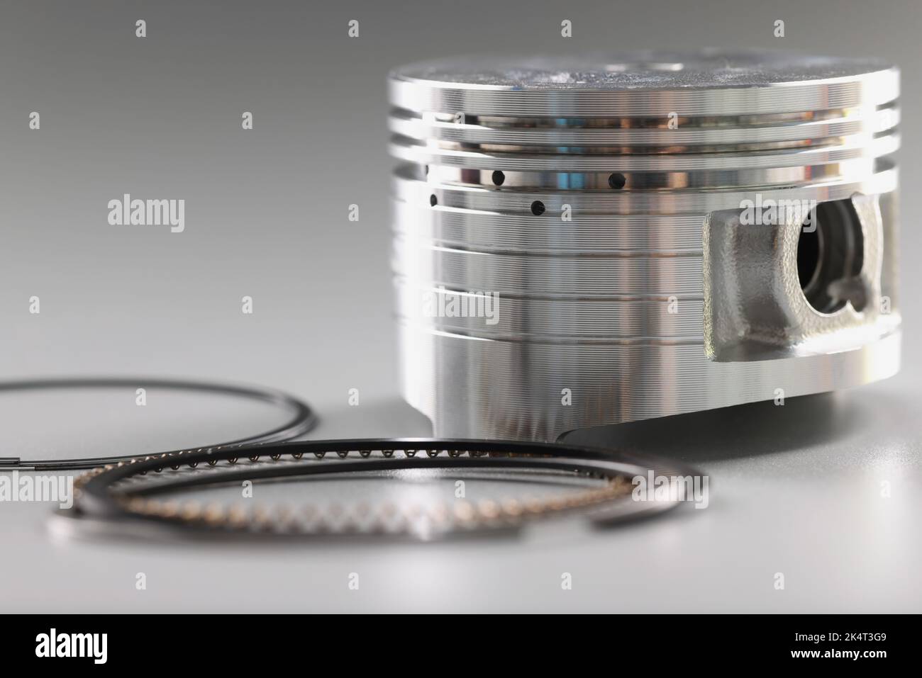 Silver round part of the engine piston, close-up Stock Photo - Alamy