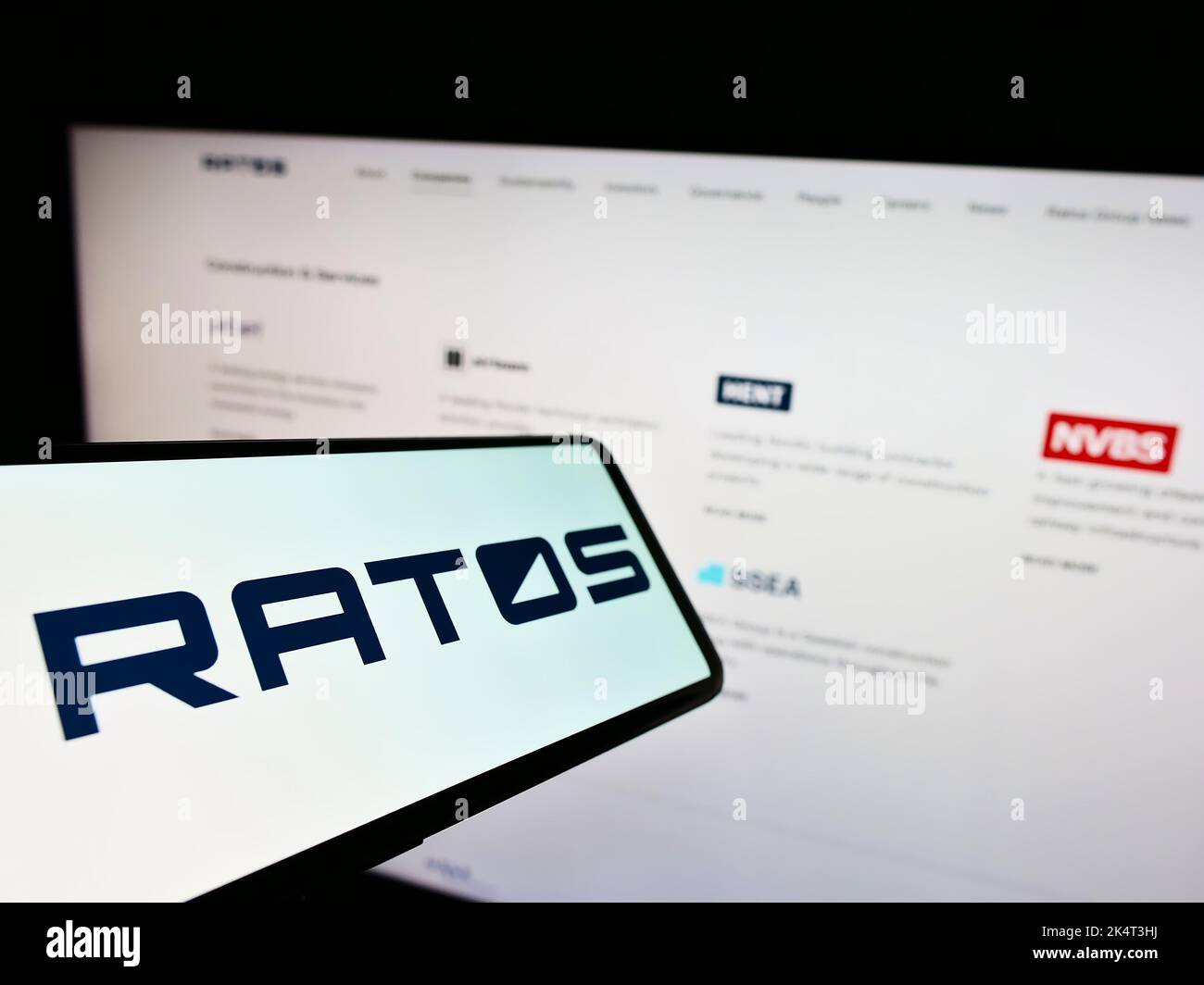 Mobile phone with logo of Swedish investment company Ratos AB on screen ...