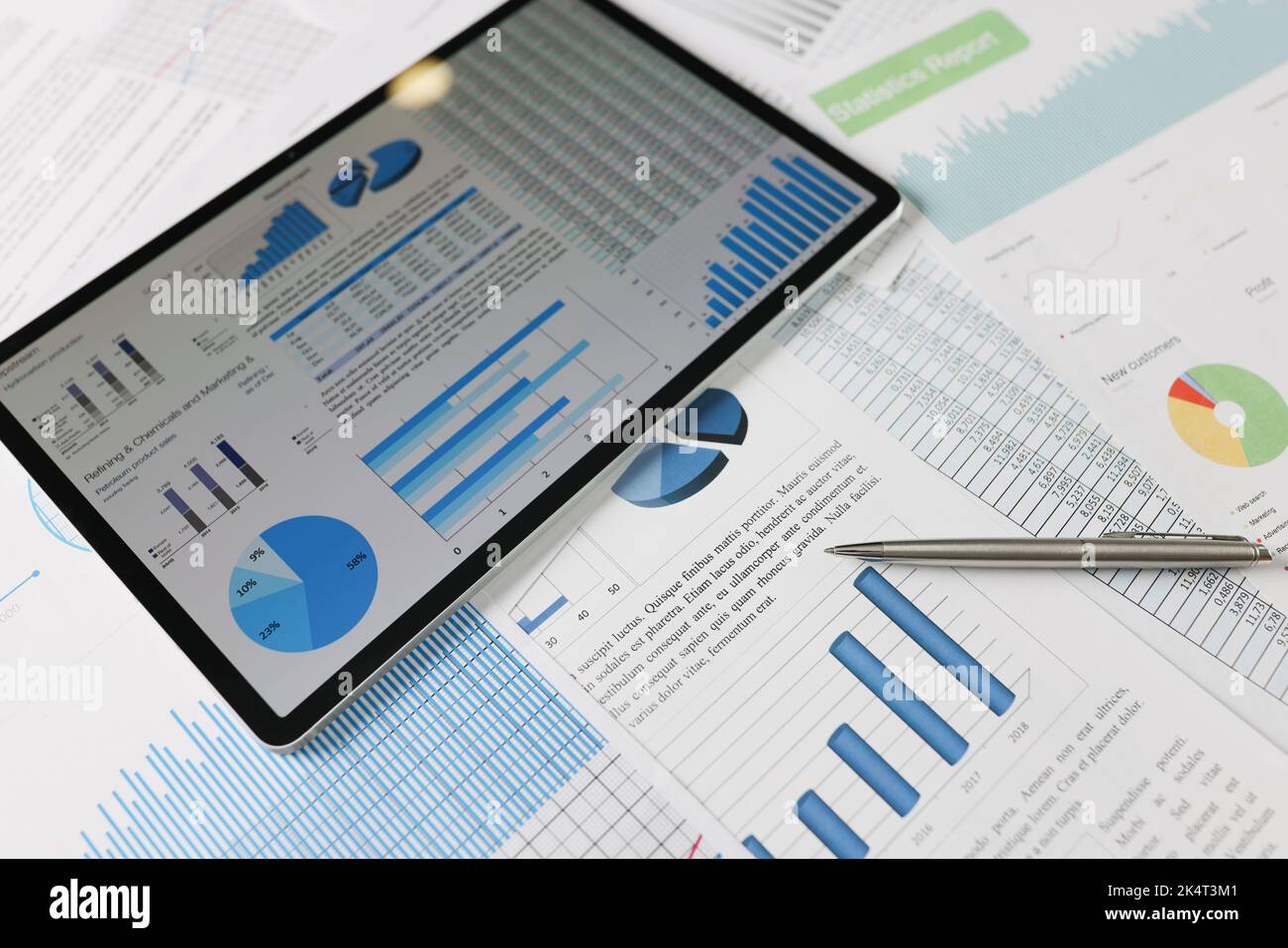 On statistical reports lies a tablet with charts on the screen Stock ...