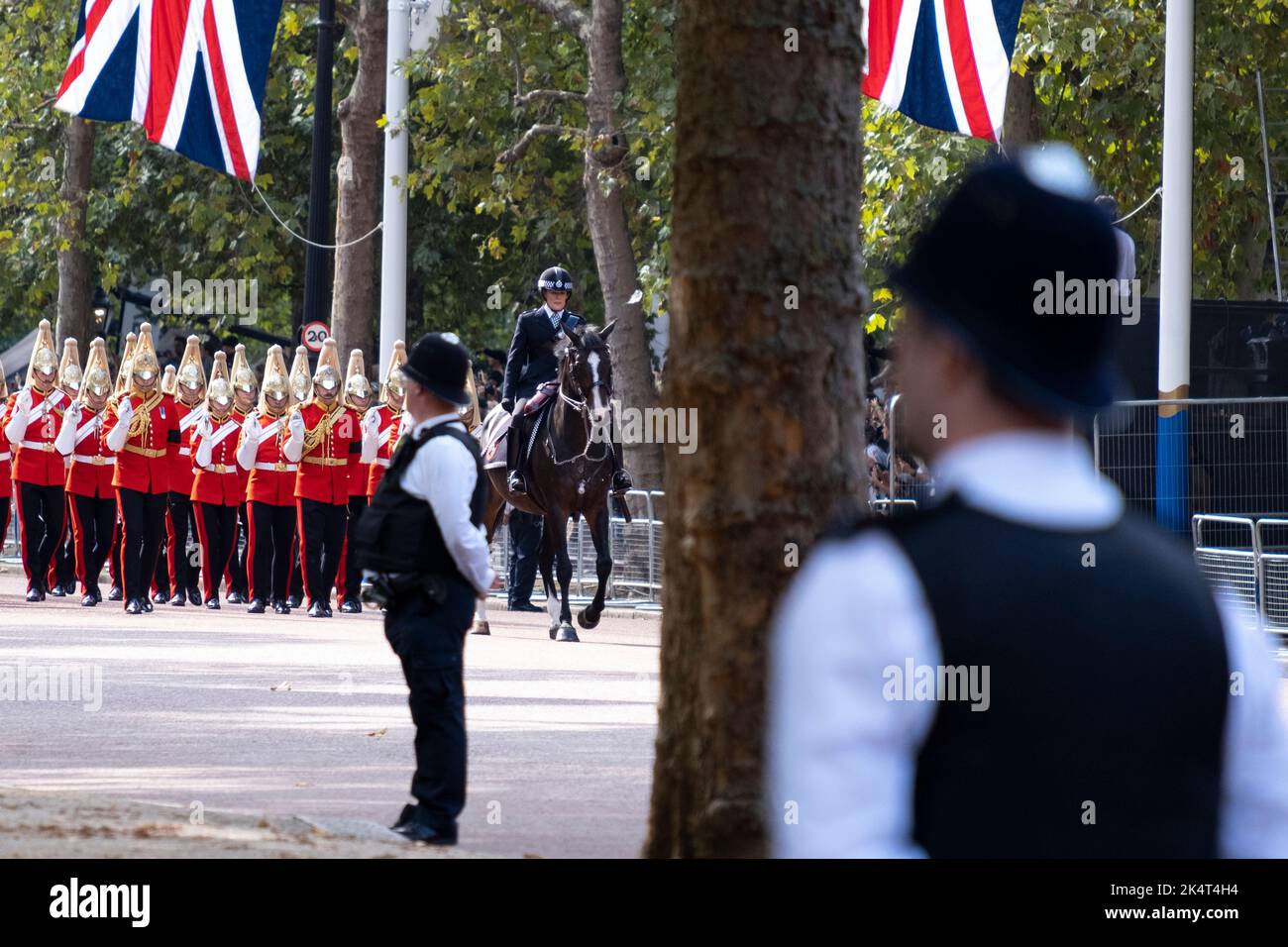 Police on duty line the route as the procession of the coffin carrying ...