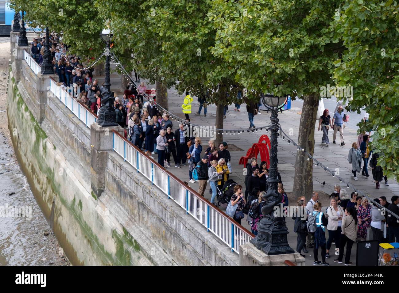 Long queues of people on the Southbank wait patiently in line to see ...