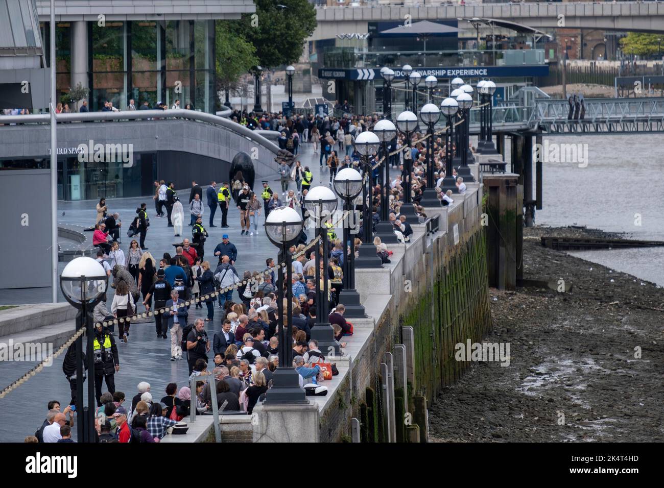 Long queues of people at More London wait patiently in line to see ...