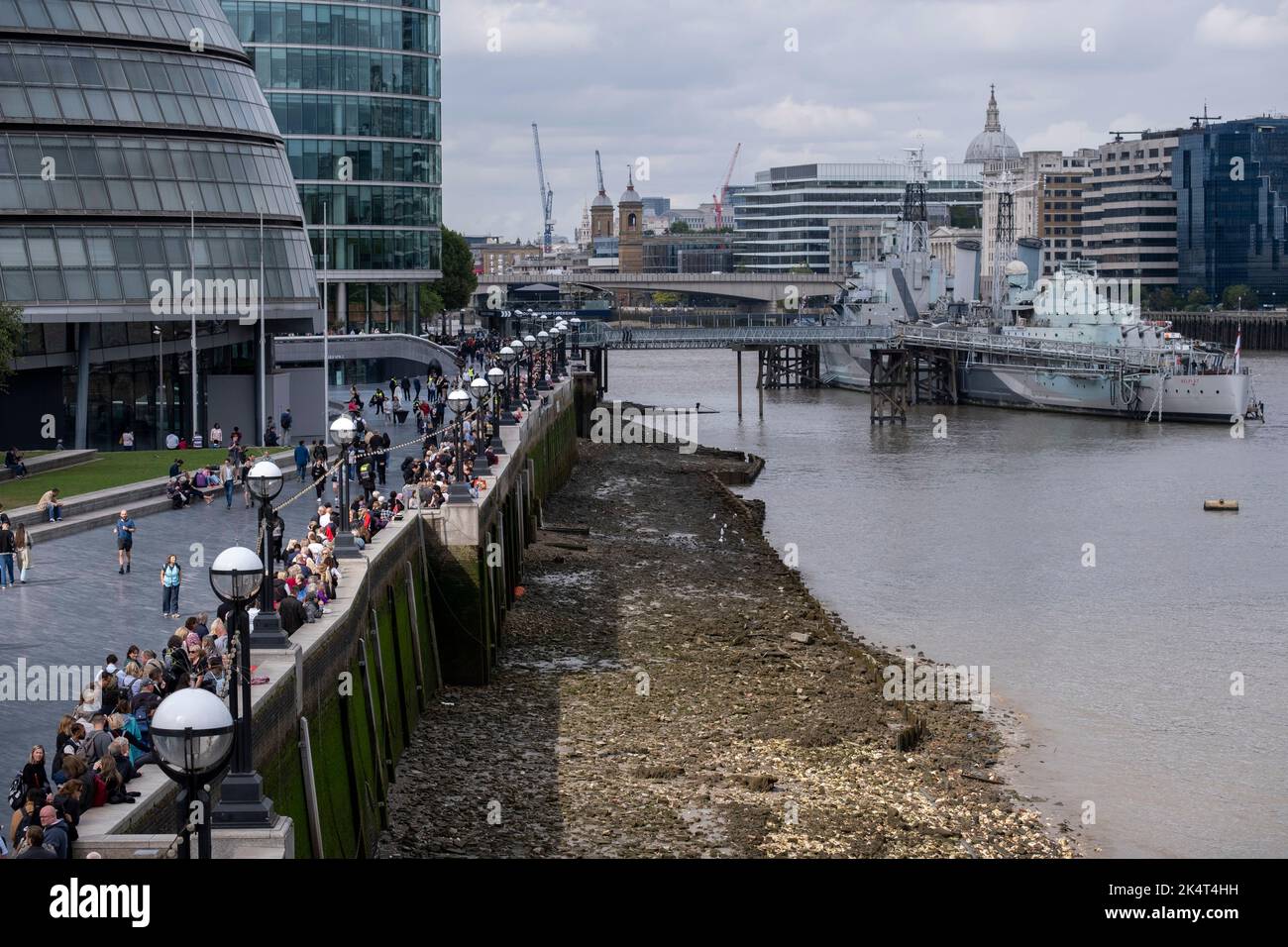 Long queues of people at More London wait patiently in line to see ...