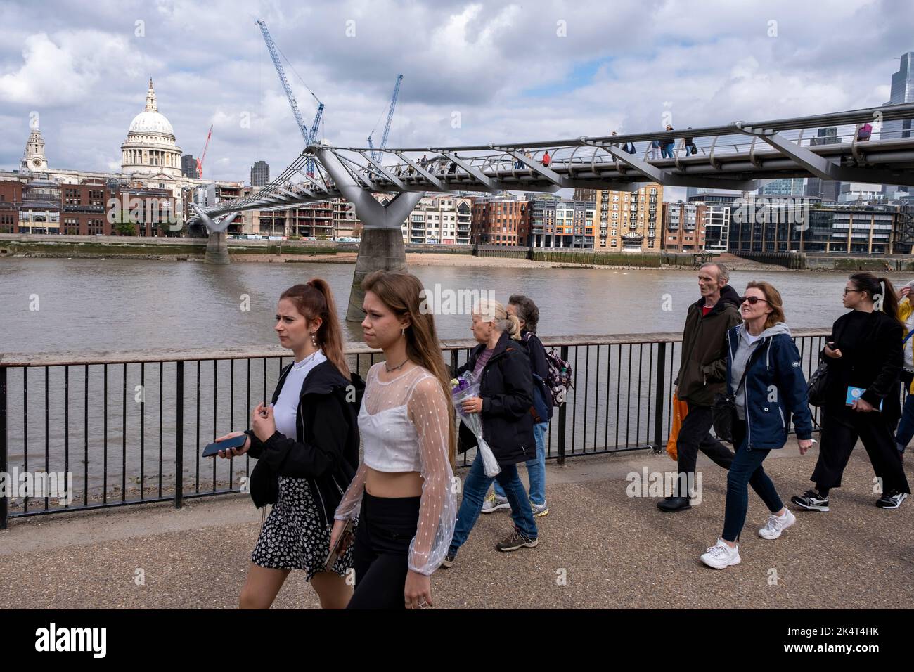 Long queues of people on the Southbank near Millennium Bridge wait ...