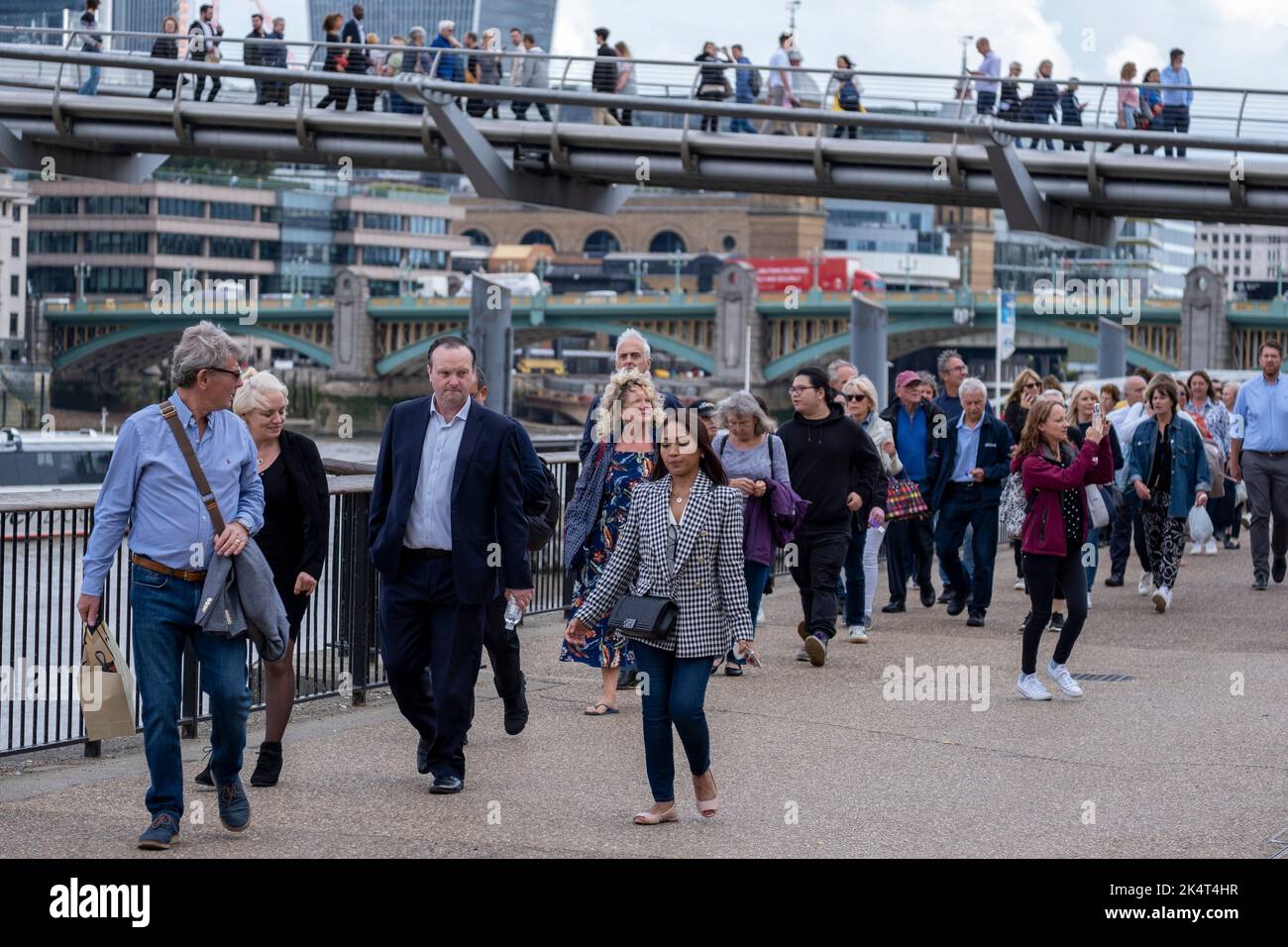 Long queues of people on the Southbank near Millennium Bridge wait ...