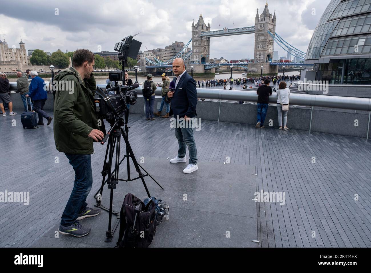 TV coverage as long queues of people at Tower Bridge wait patiently in ...