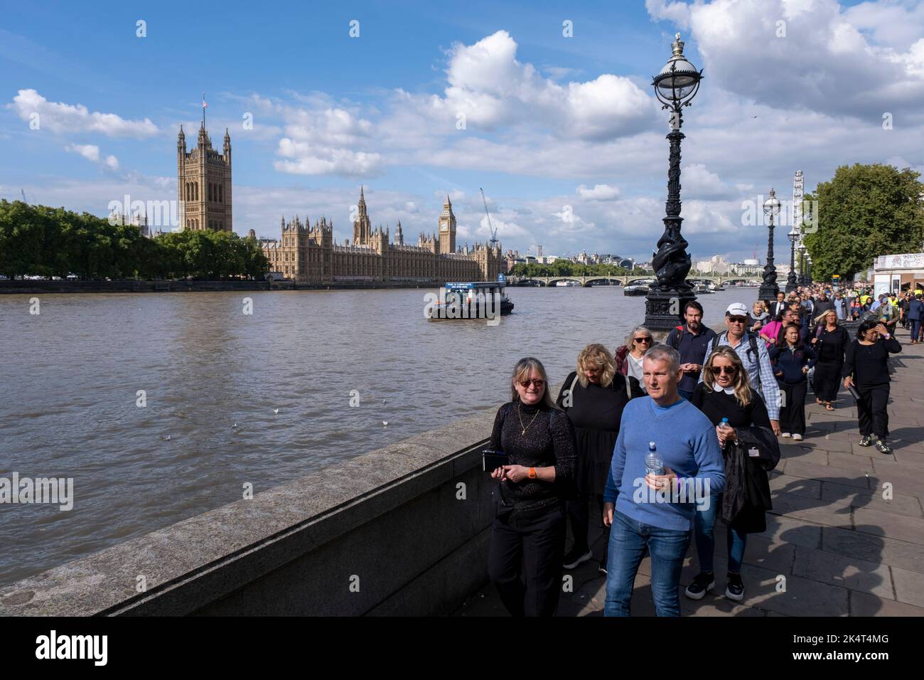 Long queues of people on the riverside walkway opposite the Houses of ...