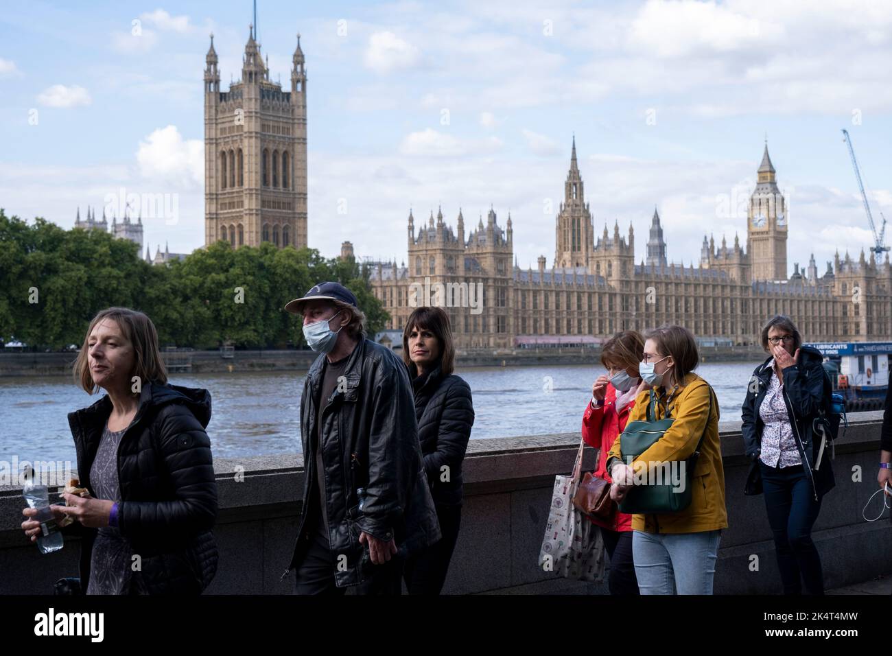 Long queues of people on the riverside walkway opposite the Houses of ...