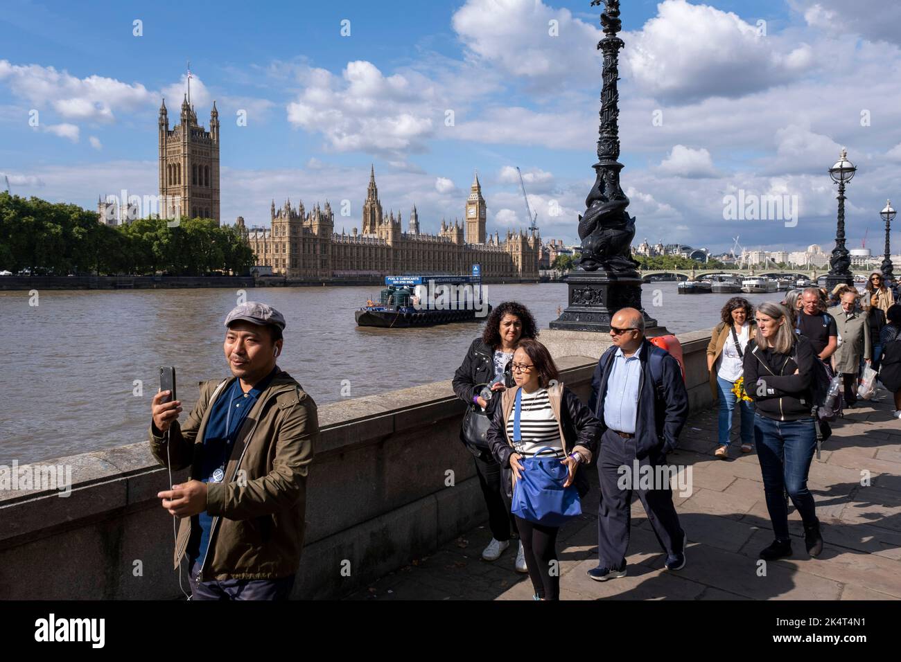 Long queues of people on the riverside walkway opposite the Houses of ...