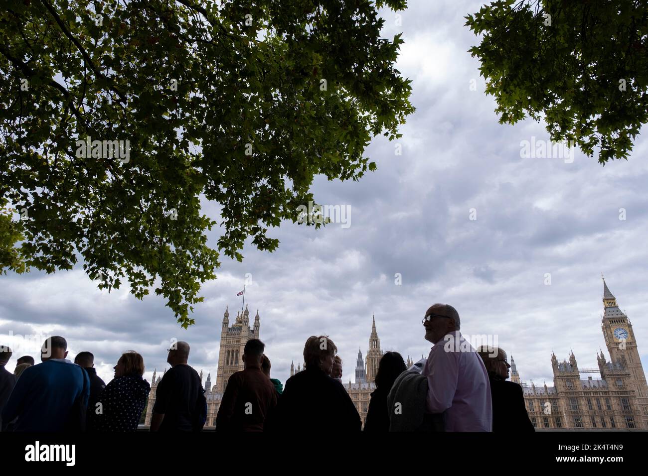 Long queues of people on the riverside walkway opposite the Houses of ...