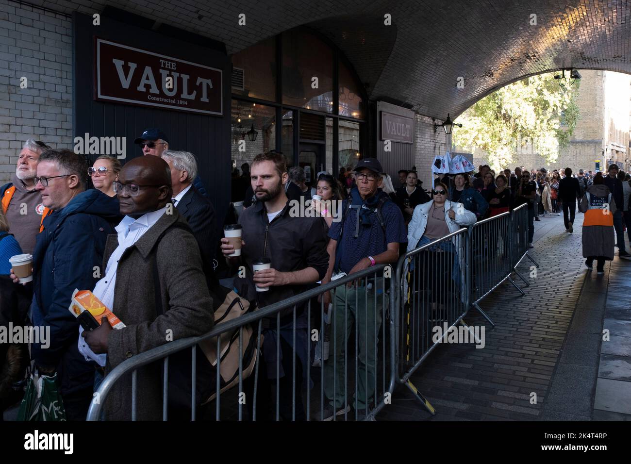 Long queues of people at Shad Thames wait patiently in line to see ...