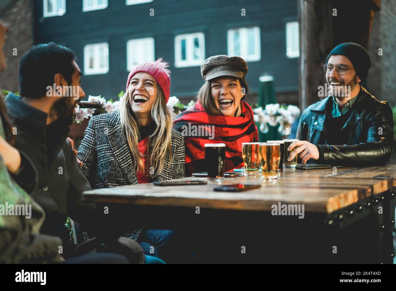 Young people having fun drinking beer at pub restaurant - Soft focus on ...