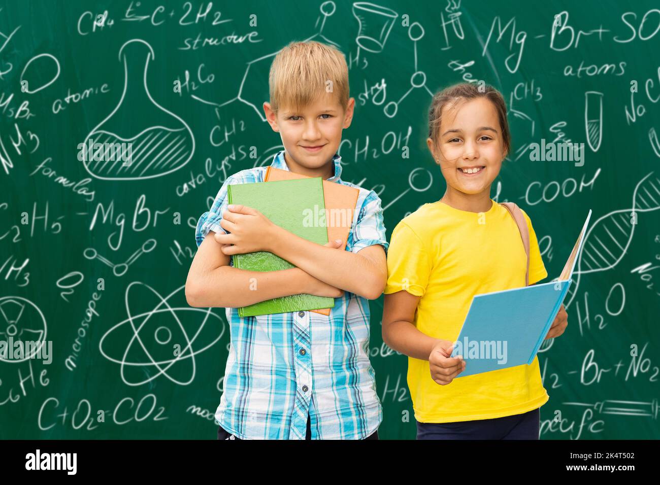 children on the background of formulas, isolated on green wall chalk ...