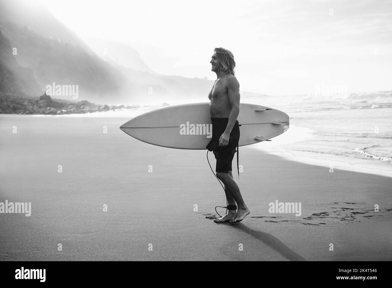 Young man having fun on the beach after surf session - Focus on face ...