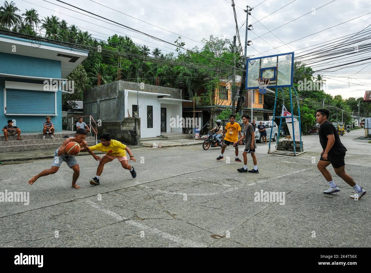 Boac, Philippines - April 2022: People playing basketball in the middle ...