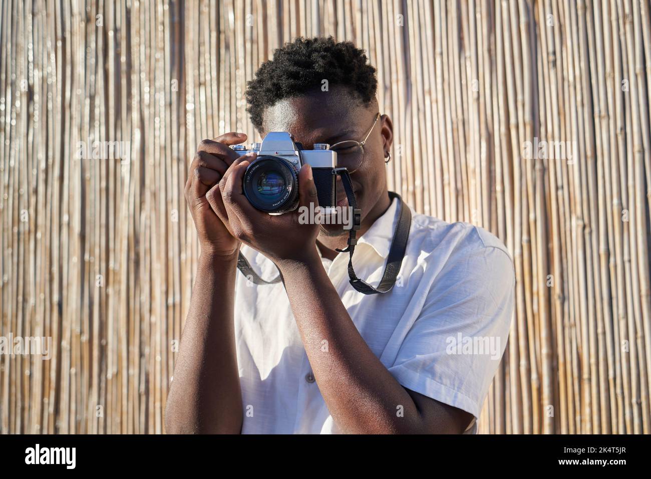 Close up portrait of photographer using an analog camera to take a ...