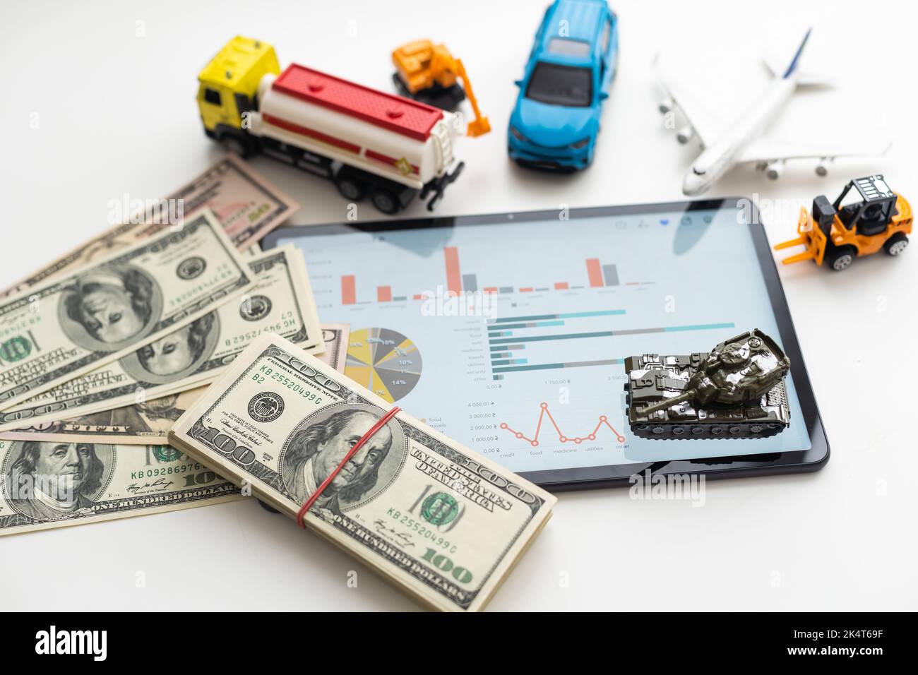 different types of toy cars and a tablet, money Stock Photo - Alamy