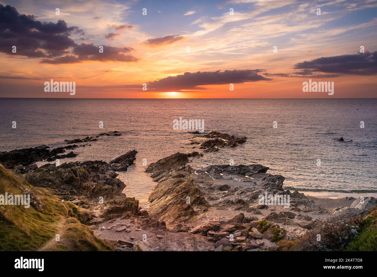 A spectacular sunset over Fistral Bay in Newquay in Cornwall in the UK ...