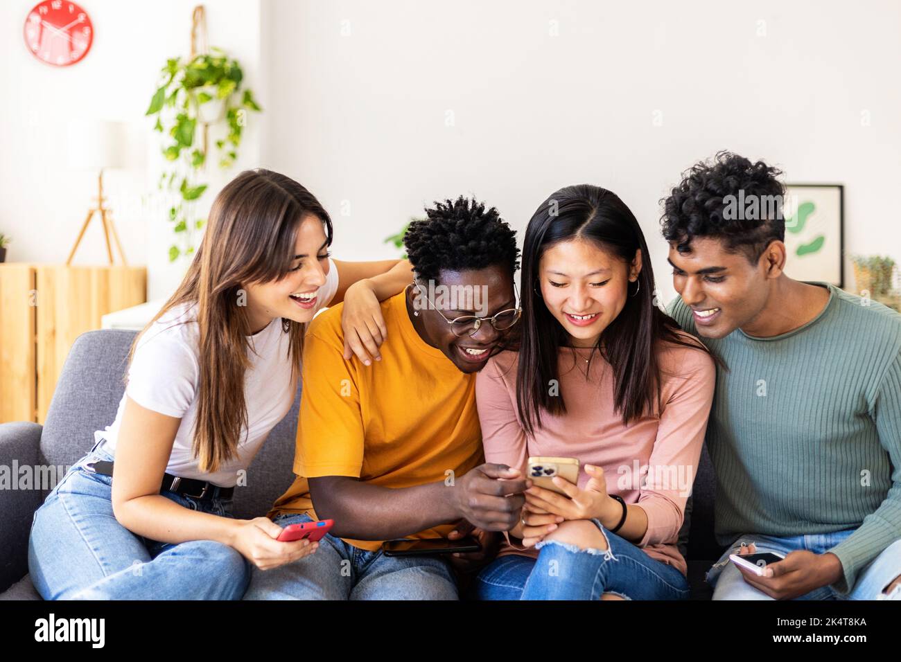 Young millennial group of multiracial friends having fun using mobile phone Stock Photo - Alamy