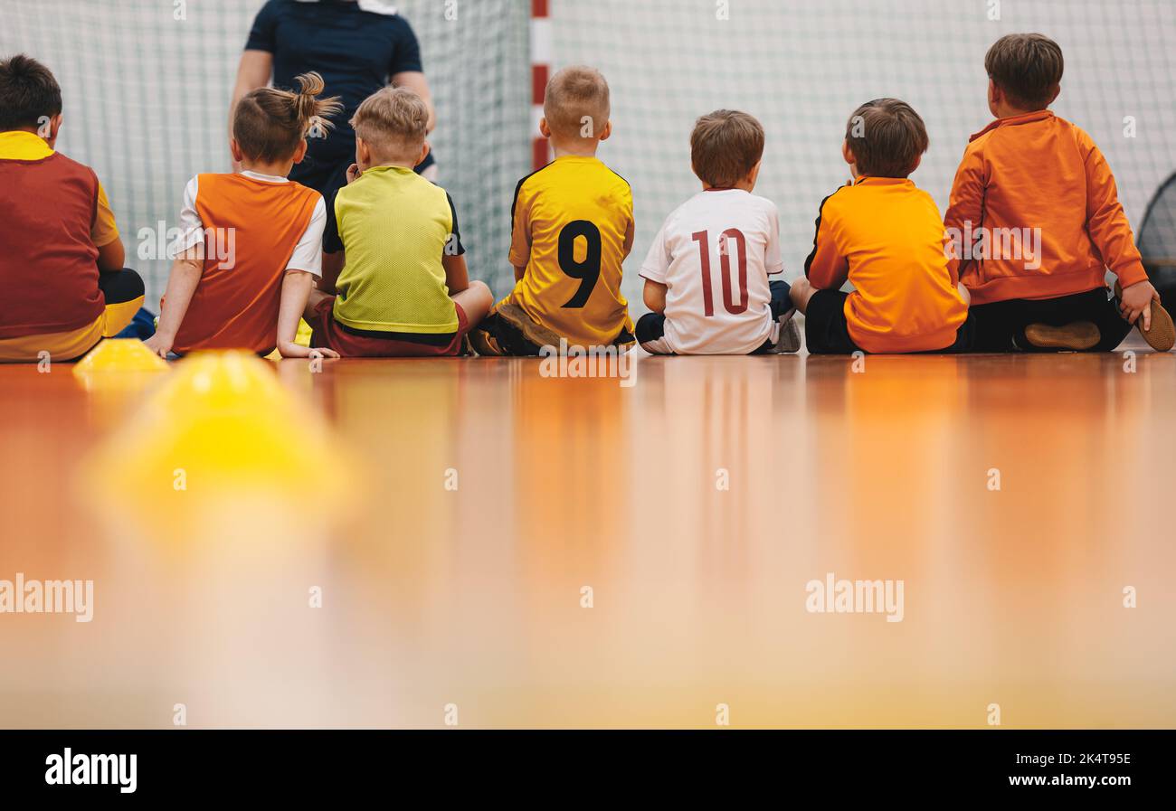 Little boys at class with young physical education teacher. Happy kids ...