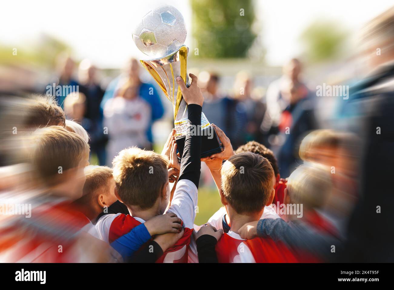 Victory celebration of a youth sports team. Happy kids winning sports tournament. Schoolboys ...