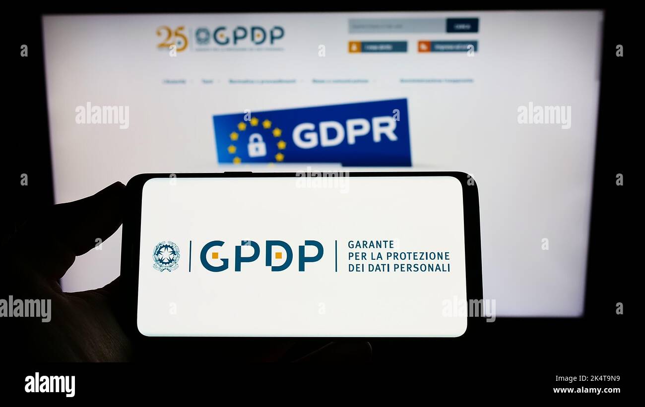 Person holding mobile phone with logo of Italian Data Protection ...
