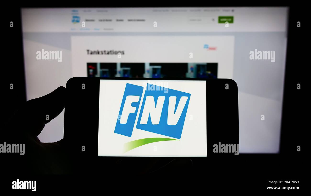 Person holding cellphone with logo of Dutch Federatie Nederlandse ...
