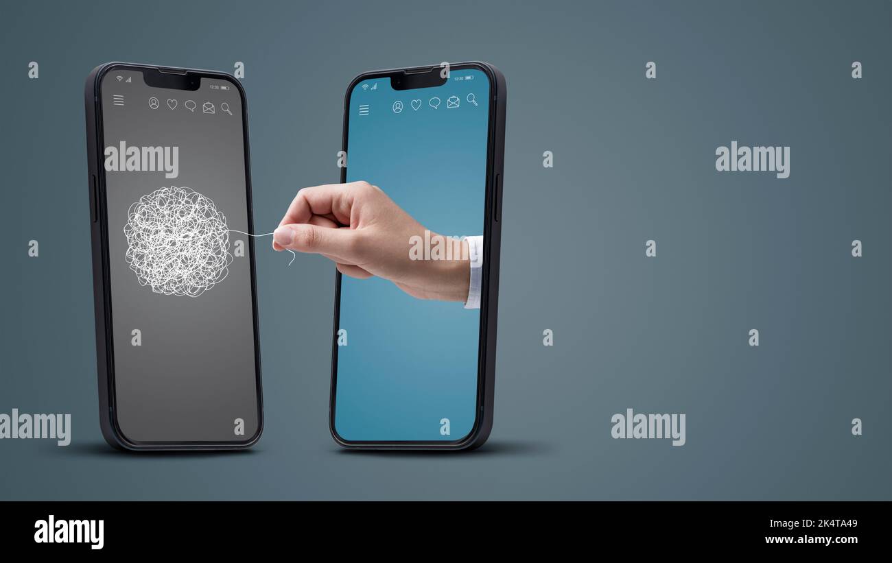 Two smartphones facing each other, a hand is untangling a line on the ...