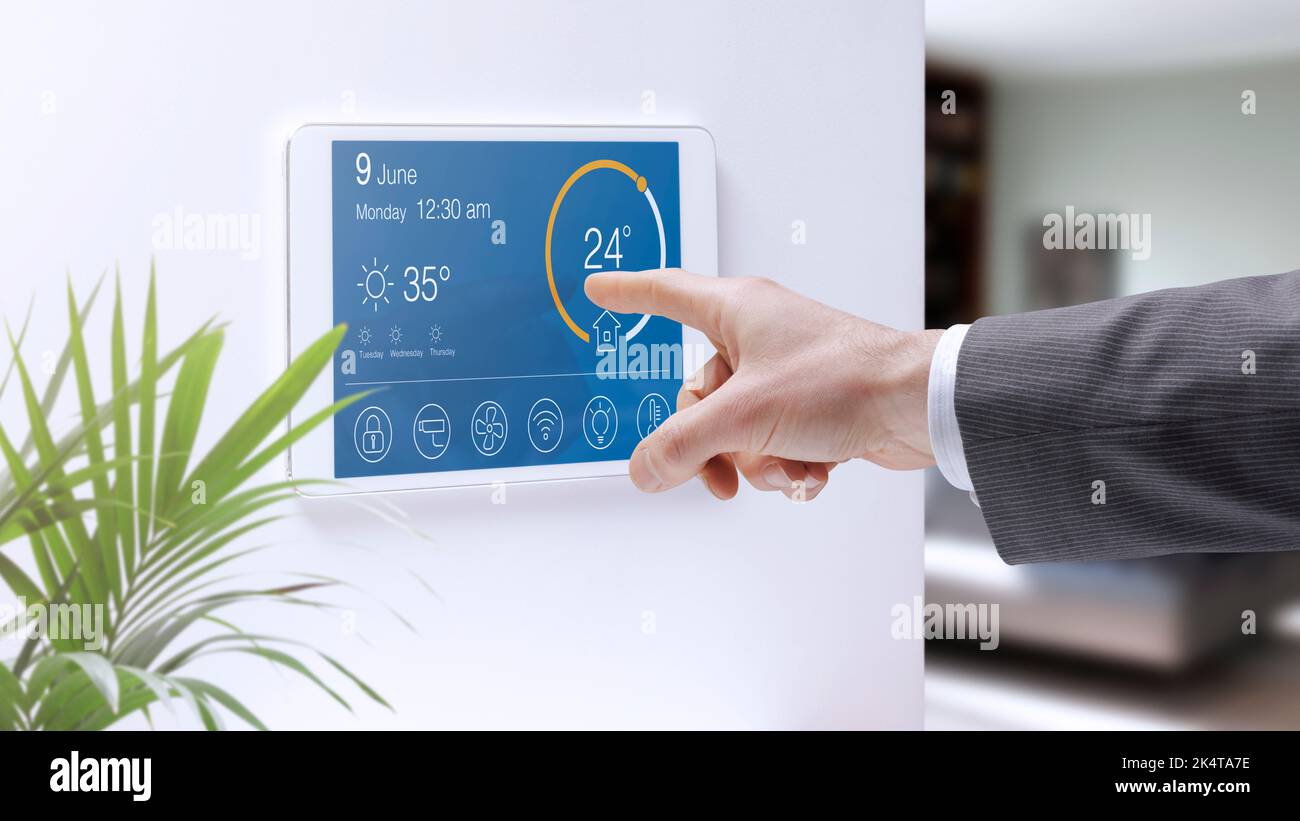 Man Setting Home Interior Temperature On The Smart Home System Control