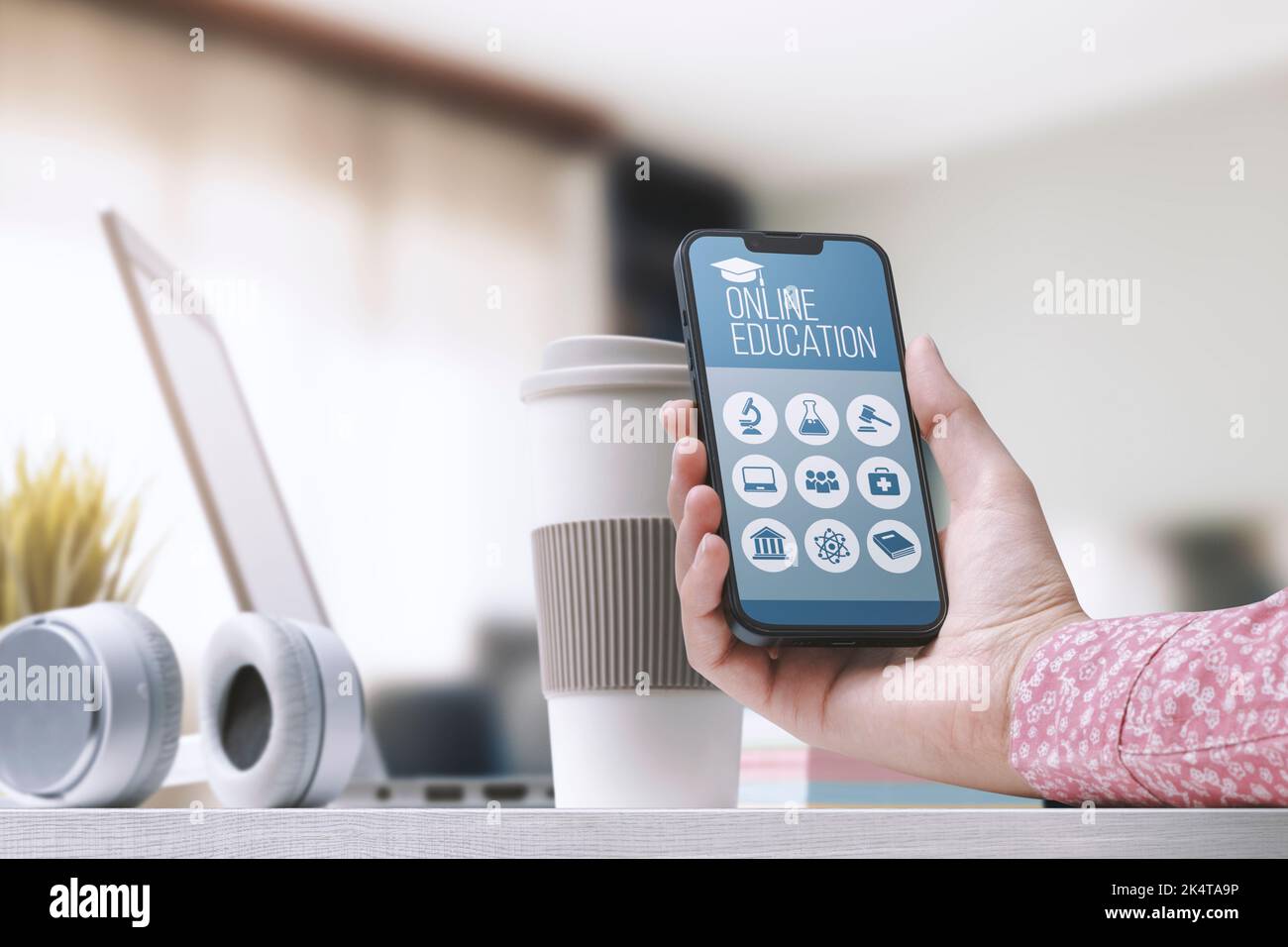 Student holding a smartphone and using online learning apps on ...