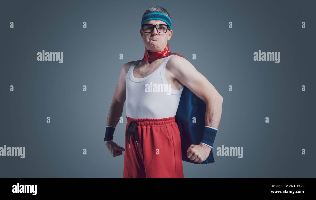 Ridiculous skynny superhero with glasses and small cape showing off ...