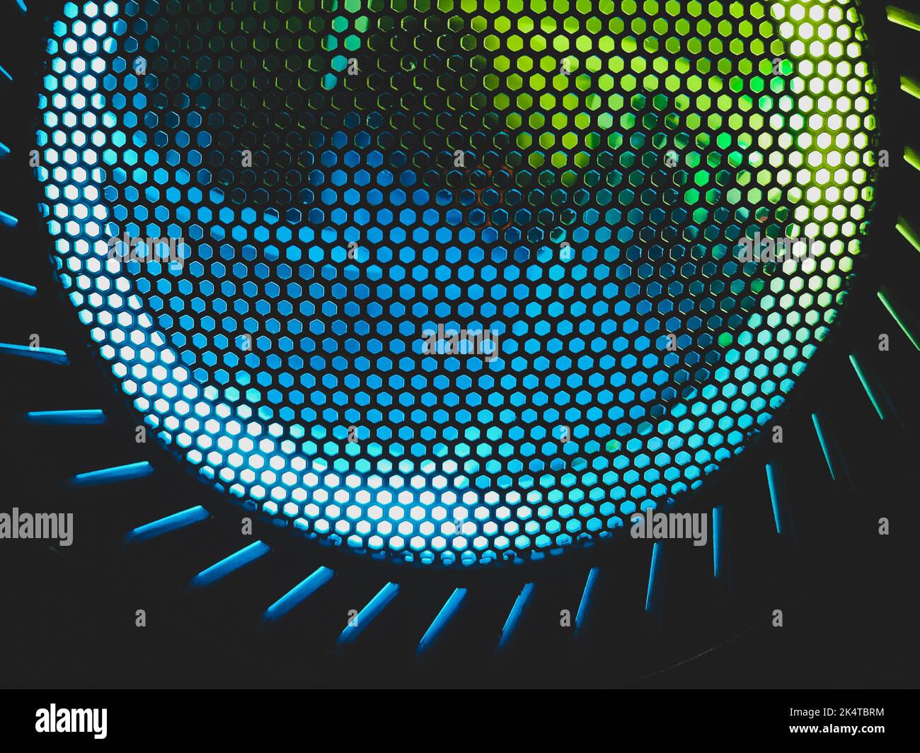Colorful led lights of computer fan shines through the protective grid ...