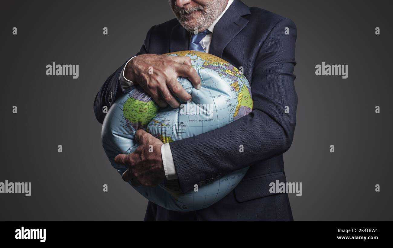 Greedy corporate businessman crushing a globe: earth exploitation and ...
