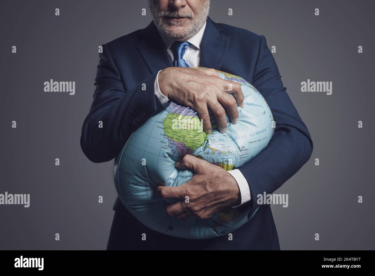 Greedy corporate businessman crushing a globe: earth exploitation and ...