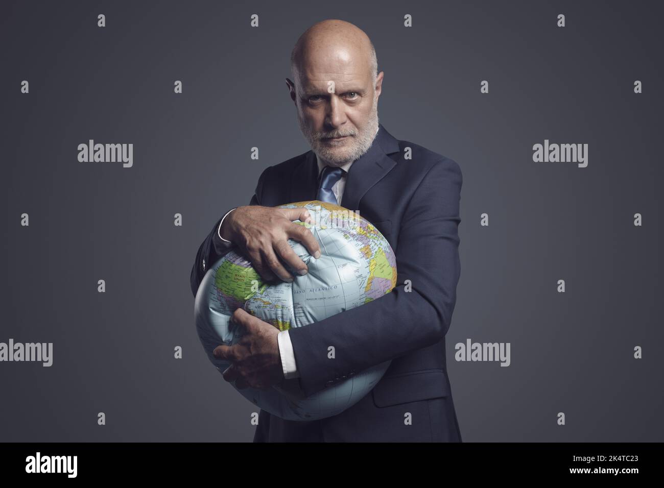 Greedy corporate businessman crushing a globe: earth exploitation and ...