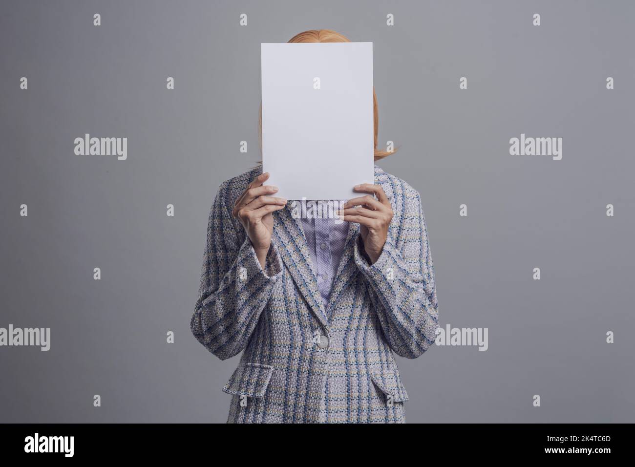 Hiding behind jacket hi-res stock photography and images - Alamy