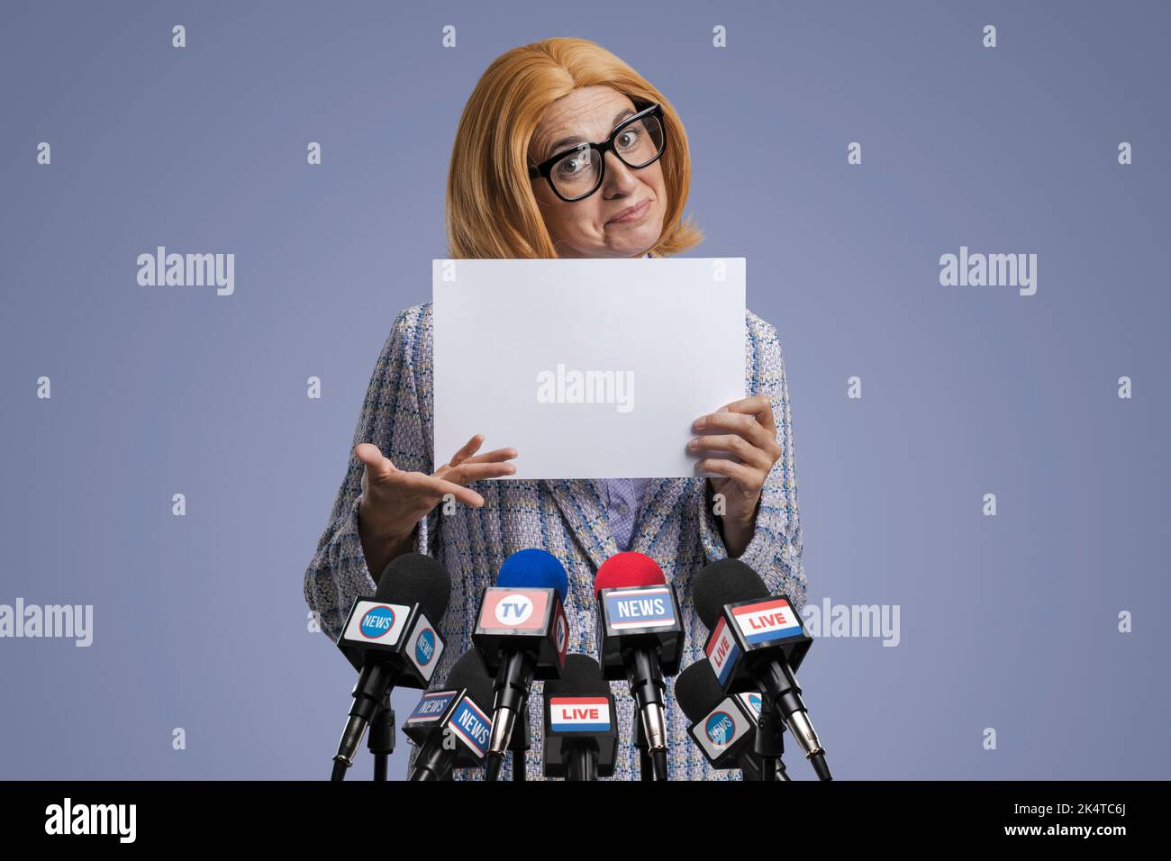 Funny smiling female politician showing a blank sign at the press ...