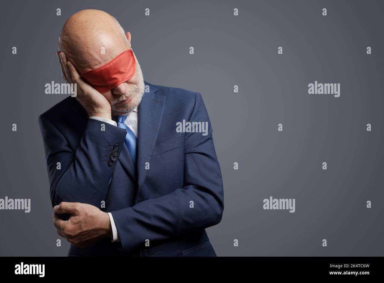 Sleepy careless businessman sleeping and wearing a sleep mask over his ...
