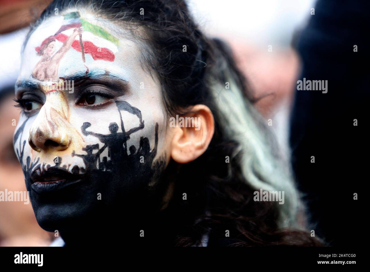 A protester wearing face-paint depicting France's iconic "Marianne ...