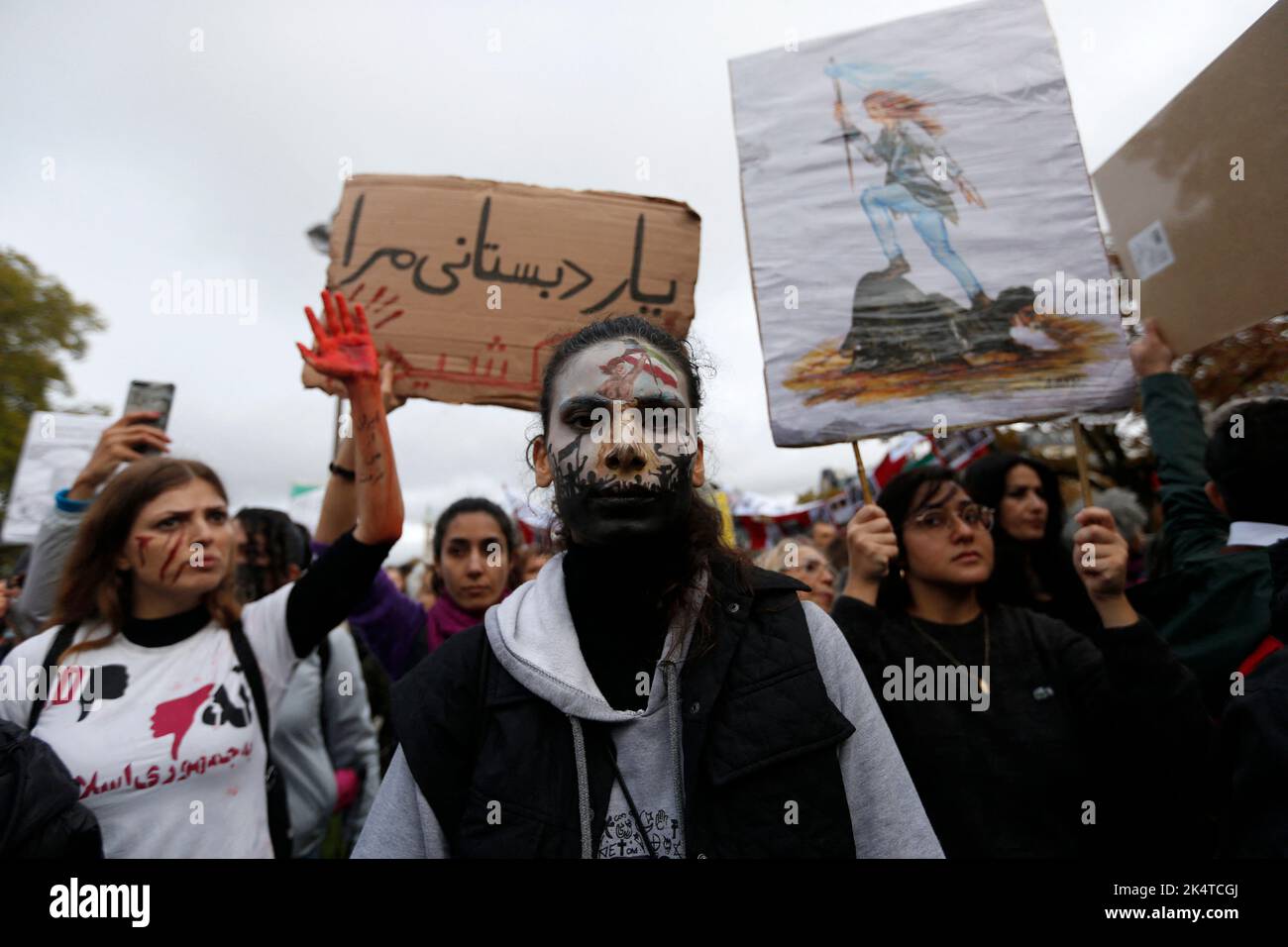 A protester wearing face-paint depicting France's iconic "Marianne ...