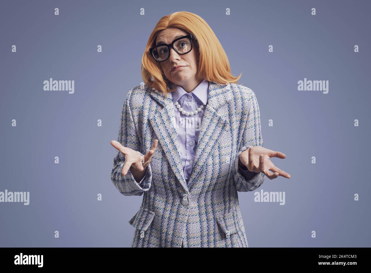 Funny confused businesswoman shrugging her shoulders and looking at ...