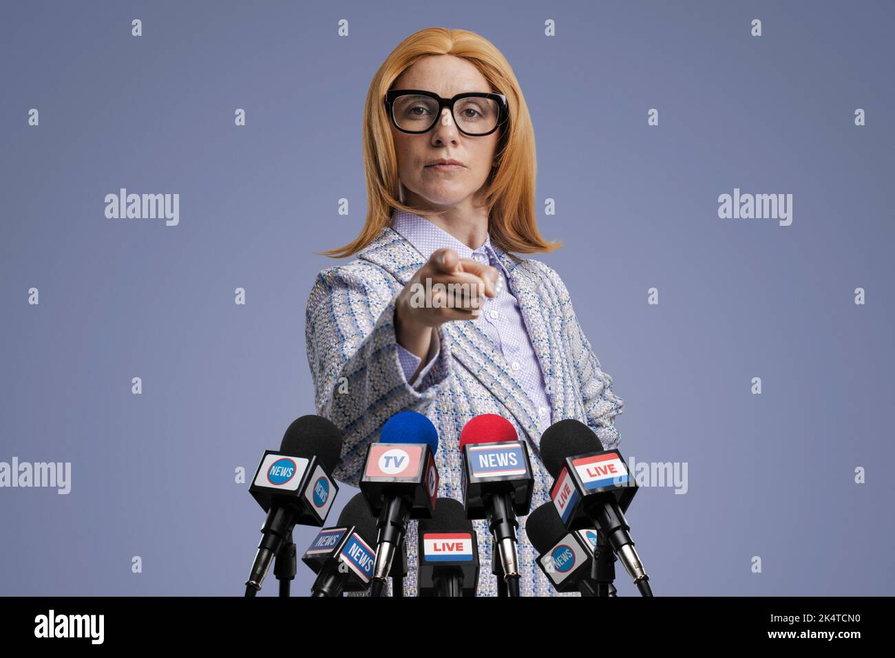 Confident female politician holding a press conference, she is pointing ...