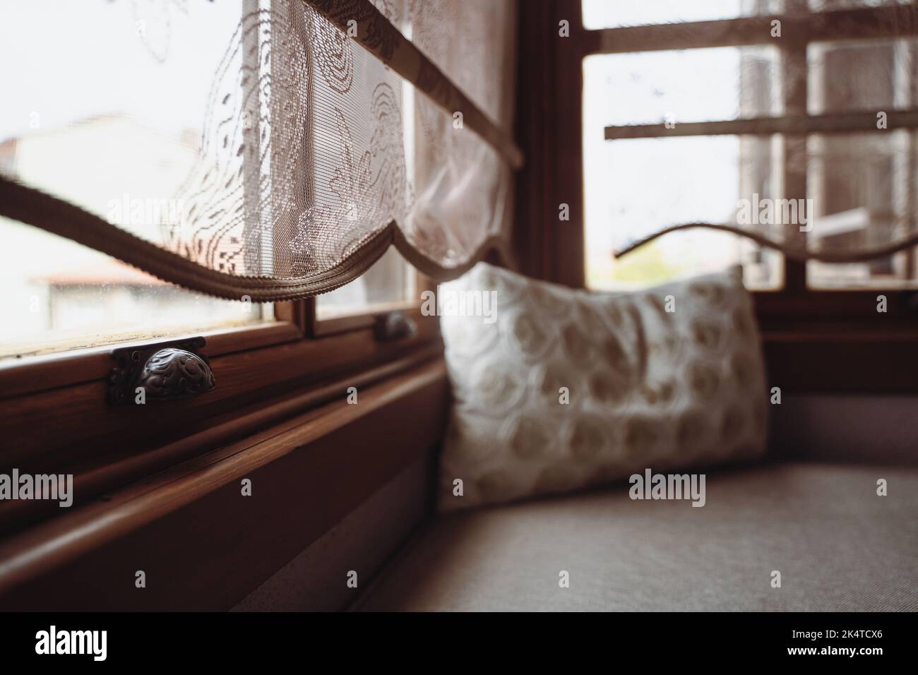 front view closeup of pillow with embroidery on divan in front of ...