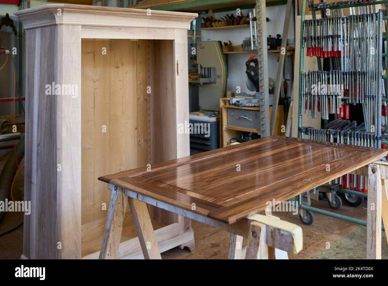 Freshly Oiled Walnut Cabinet Door Drying On Wooden Trestles In Front Of ...
