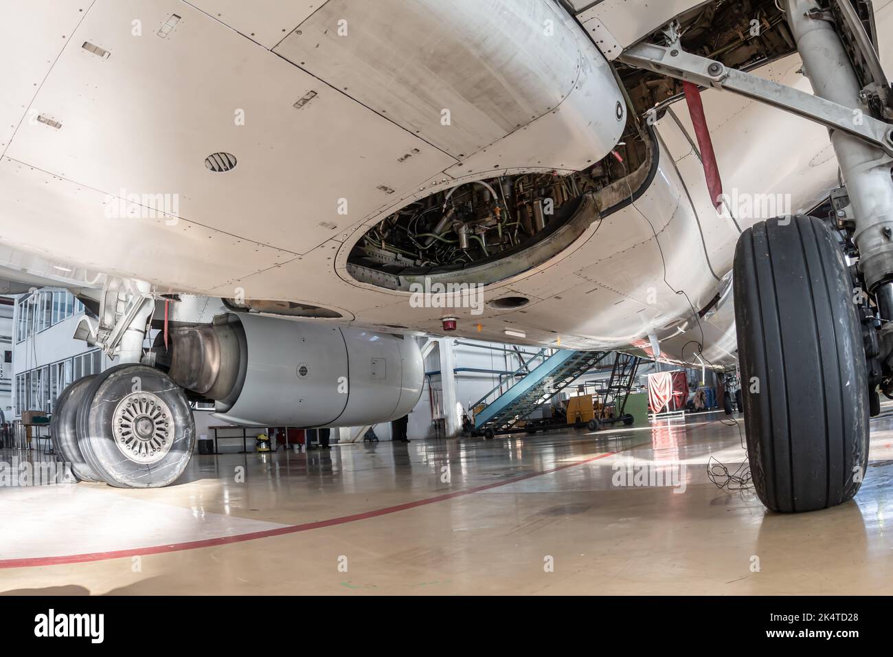 Close-up on the main landing gear of a white passenger aircraft and the ...