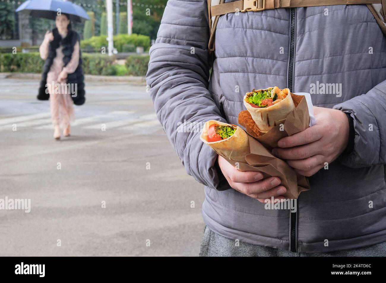 Shawarma takeaway. Roasted meat with vegetables and sauce, shaved for ...