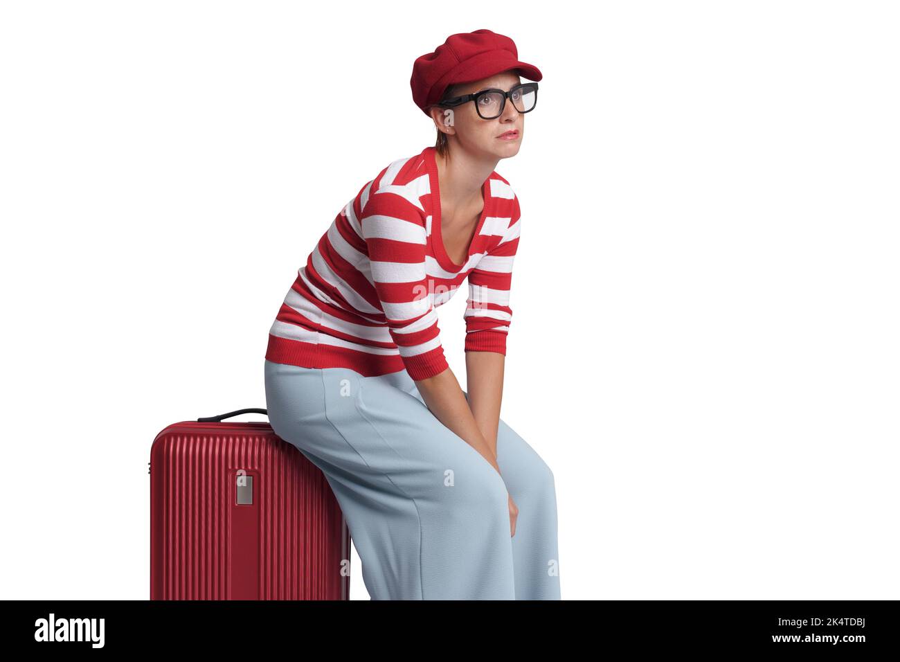 Sad disappointed traveler woman sitting on her suitcase and waiting ...