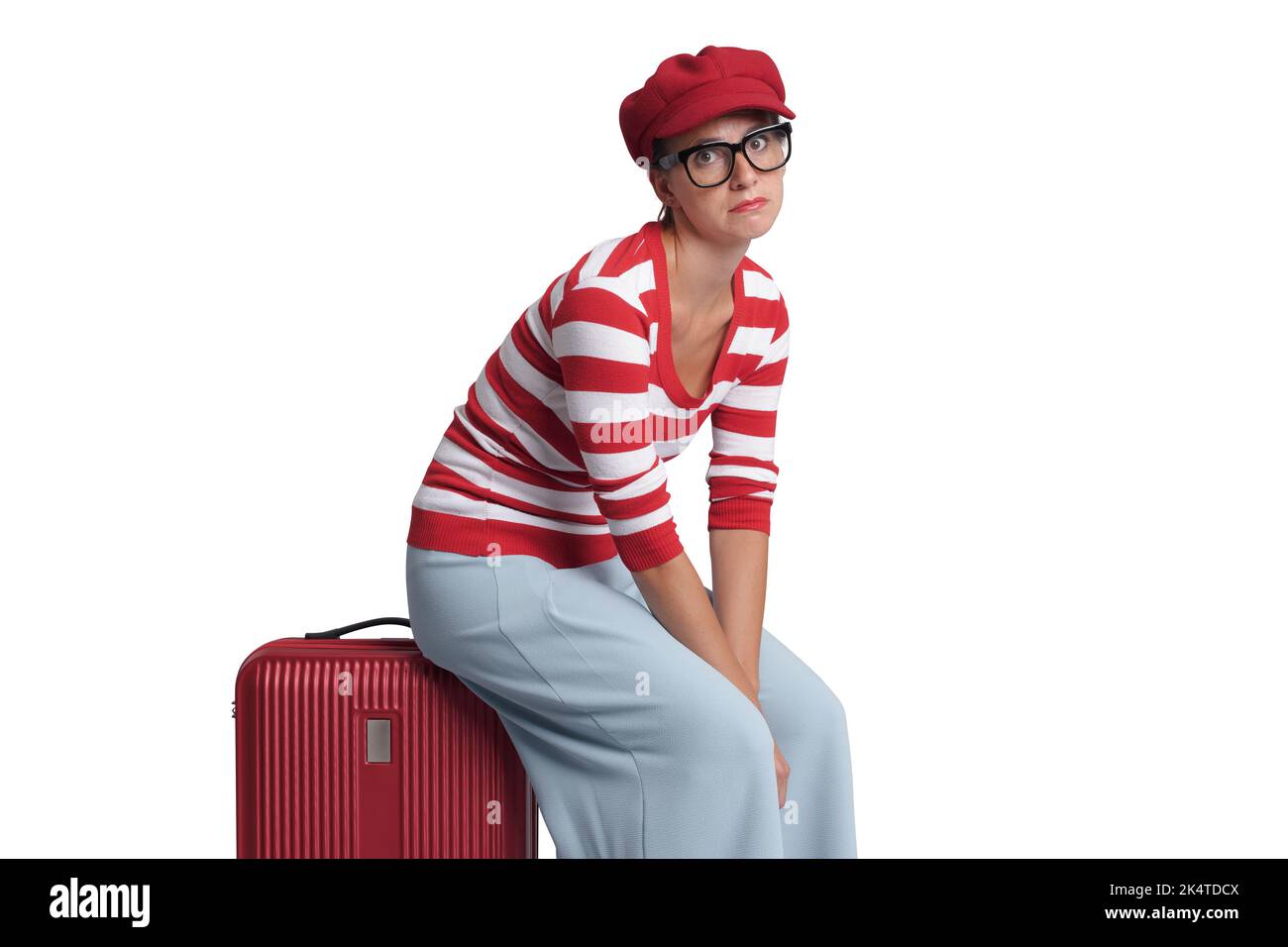 Sad disappointed traveler woman sitting on her suitcase and waiting ...