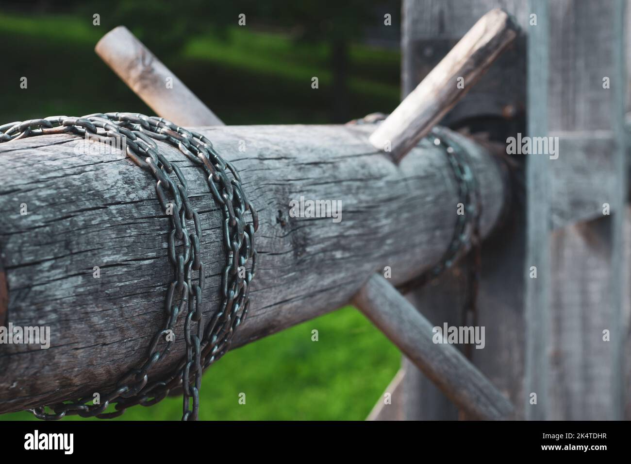 Old wooden winch of well with chain. lifting mechanism of water from ...