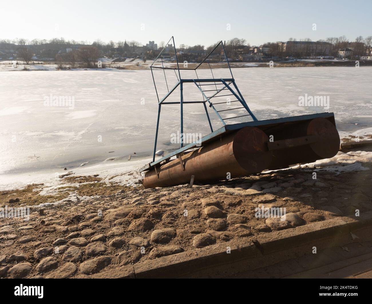 Small pontoon boat with iron construction on the paved shore Stock ...